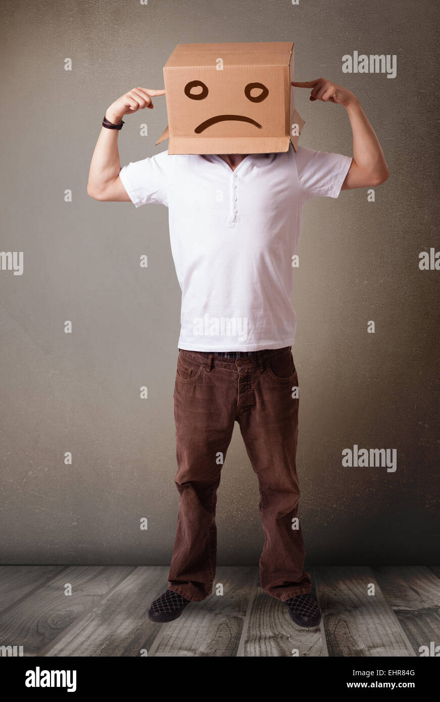 Young man with a brown cardboard box on his head with sad face Stock ...