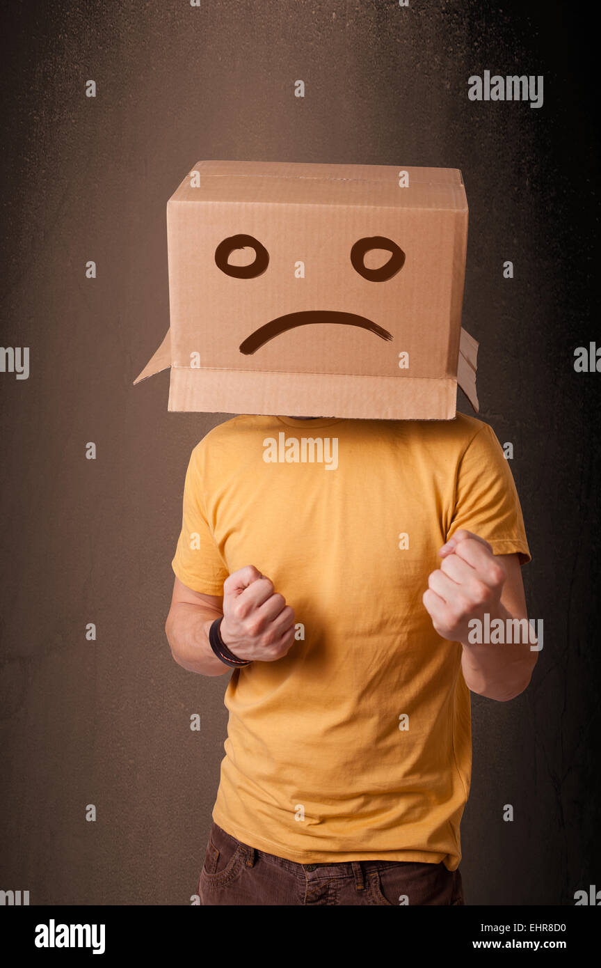 Young man with a brown cardboard box on his head with sad face Stock ...