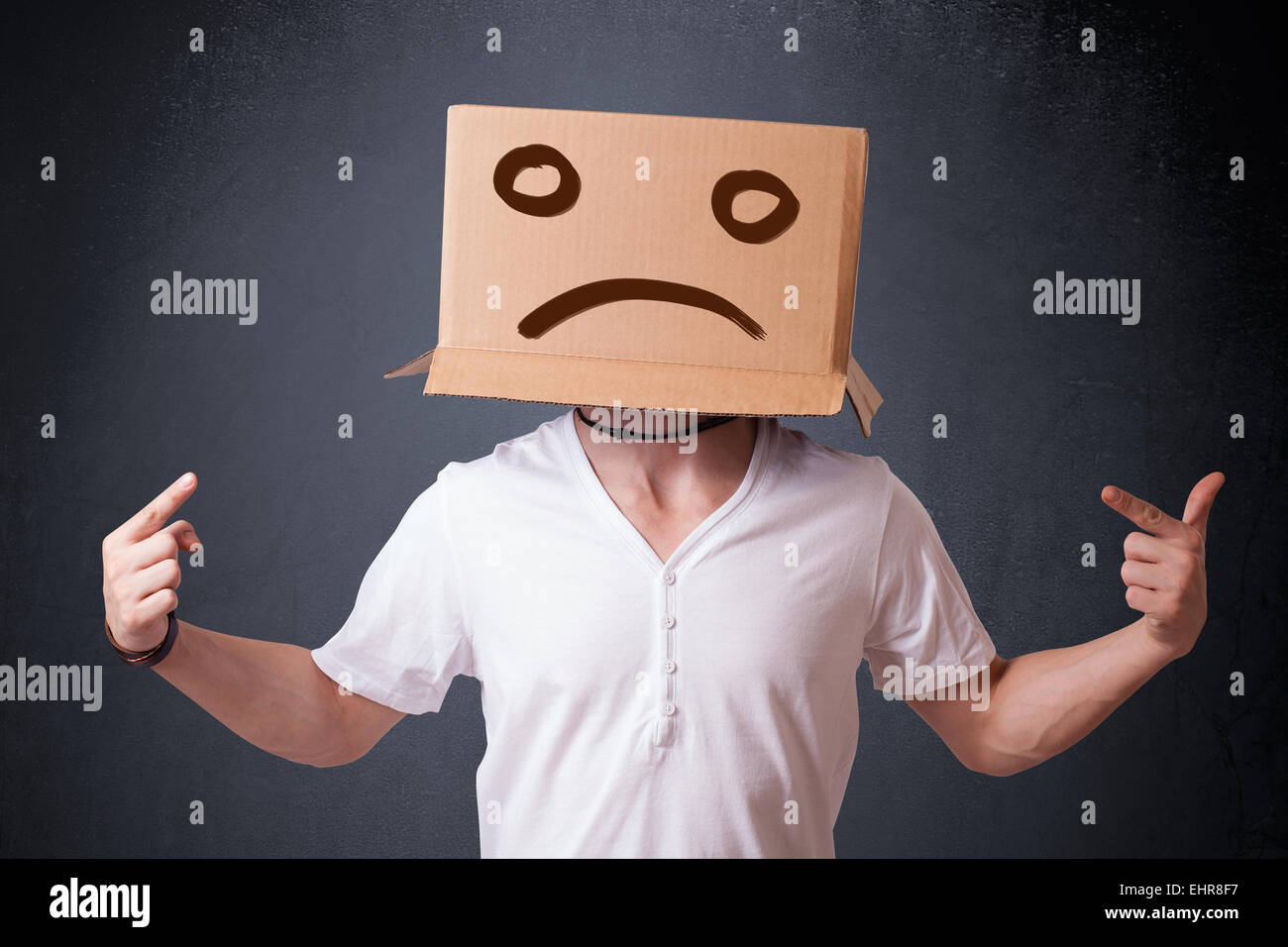 Young man with a brown cardboard box on his head with sad face Stock ...