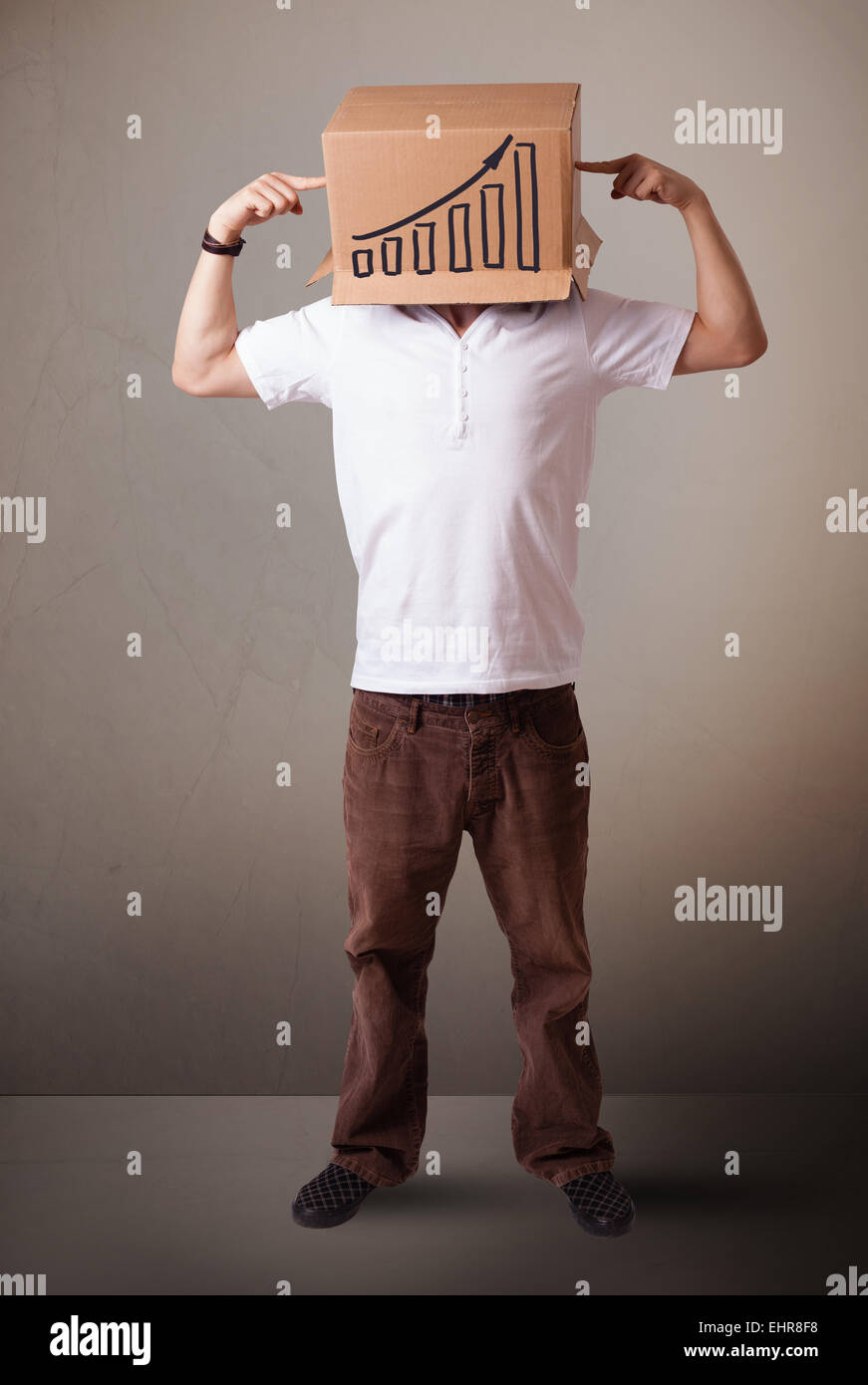 Young man gesturing with a cardboard box on his head with diagram Stock ...
