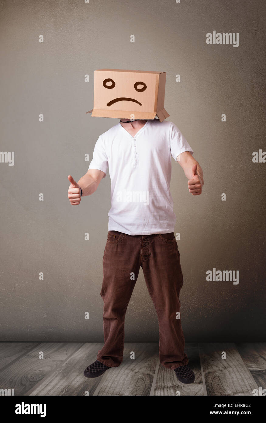 Young man with a brown cardboard box on his head with sad face Stock ...