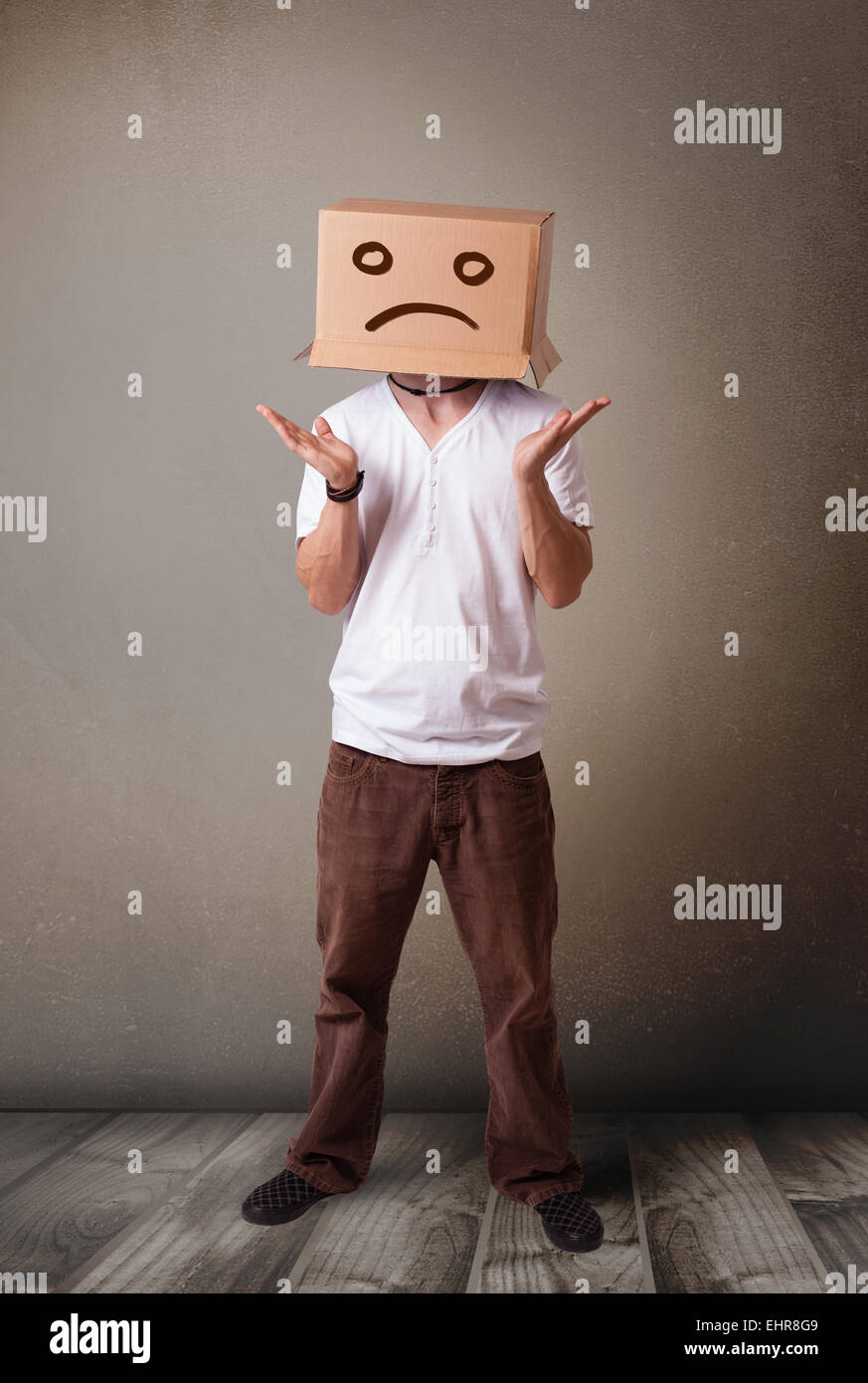 Young man with a brown cardboard box on his head with sad face Stock ...