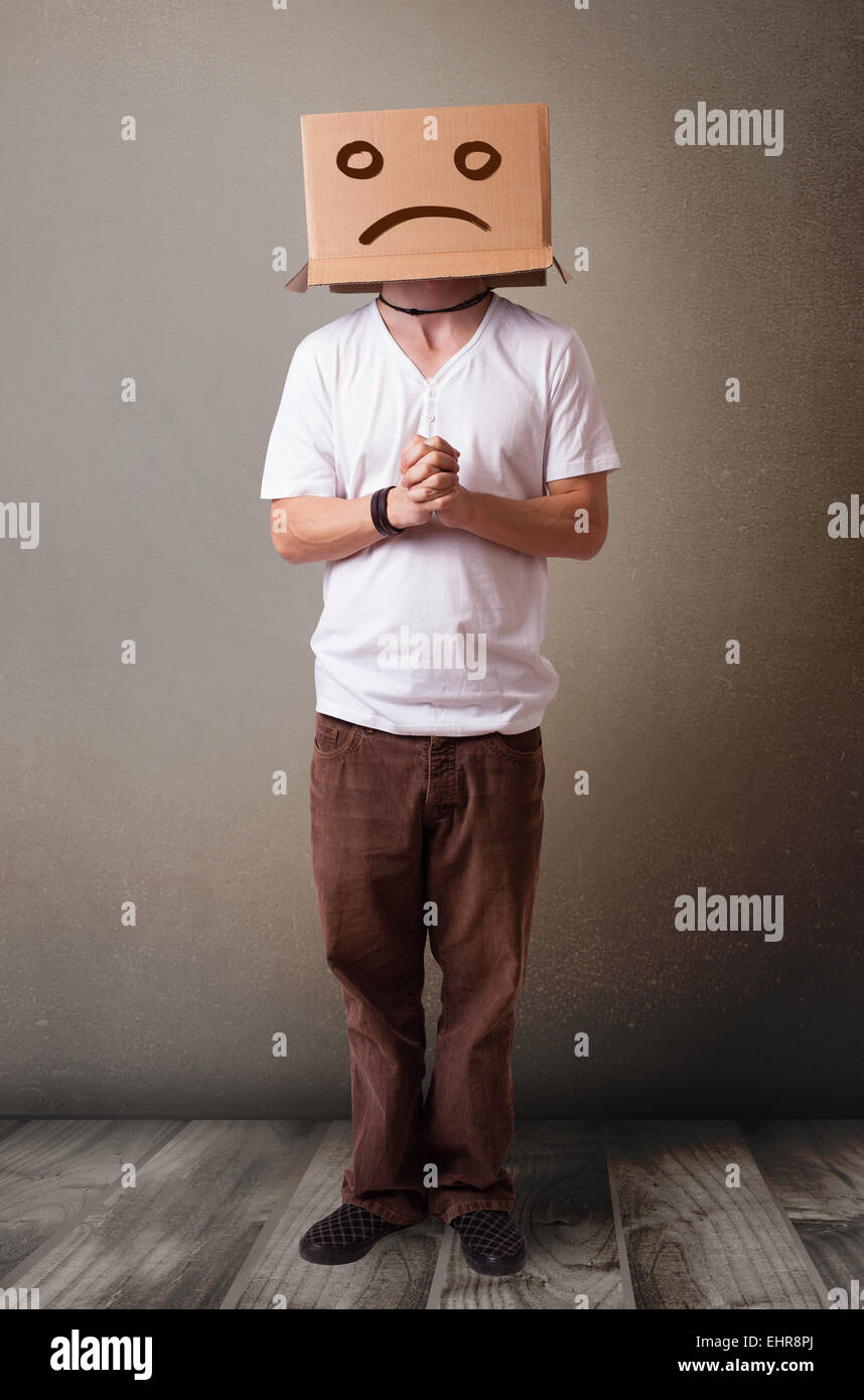 Young man with a brown cardboard box on his head with sad face Stock ...