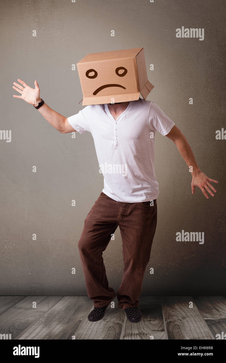 Young man with a brown cardboard box on his head with sad face Stock ...