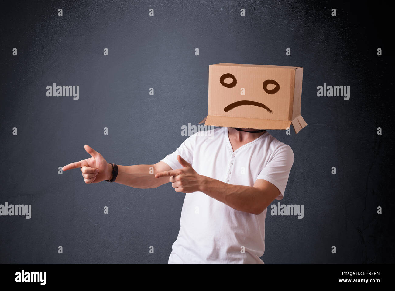 Young man with a brown cardboard box on his head with sad face Stock ...