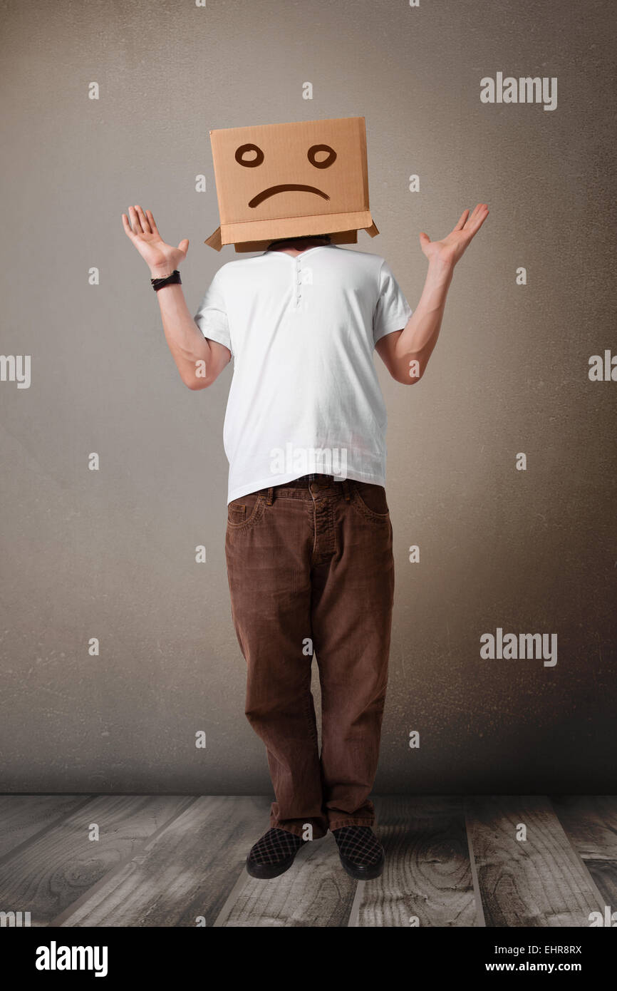 Young man with a brown cardboard box on his head with sad face Stock ...