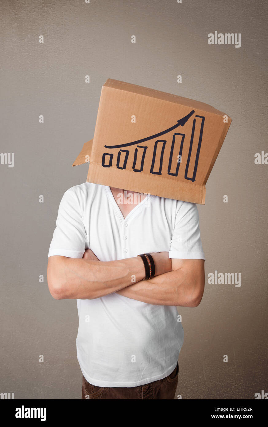 Young man gesturing with a cardboard box on his head with diagram Stock ...