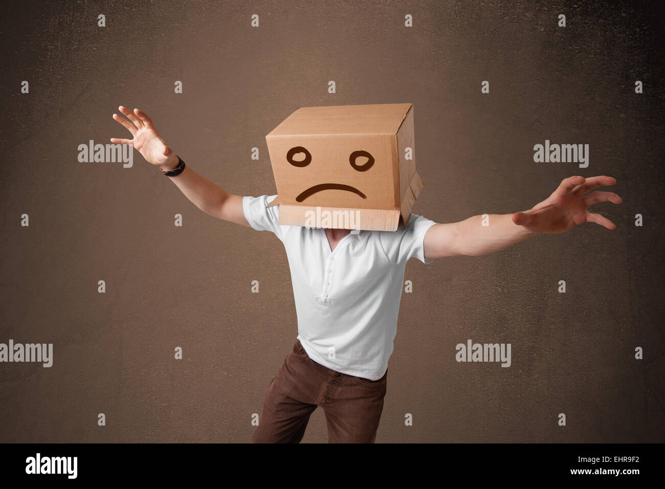 Young man with a brown cardboard box on his head with sad face Stock ...