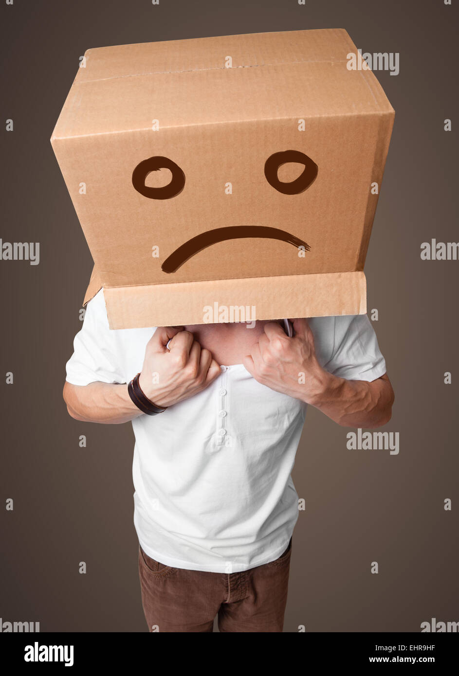 Young man with a brown cardboard box on his head with sad face Stock ...