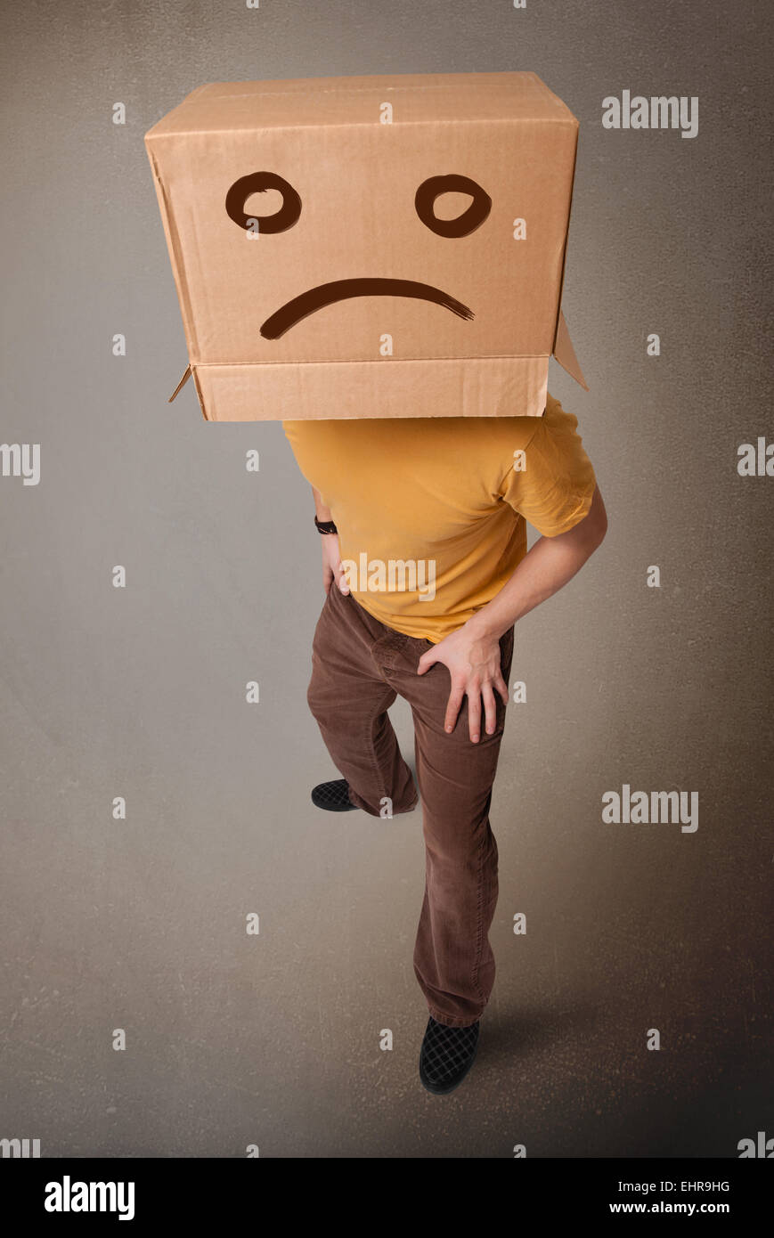 Young man with a brown cardboard box on his head with sad face Stock ...