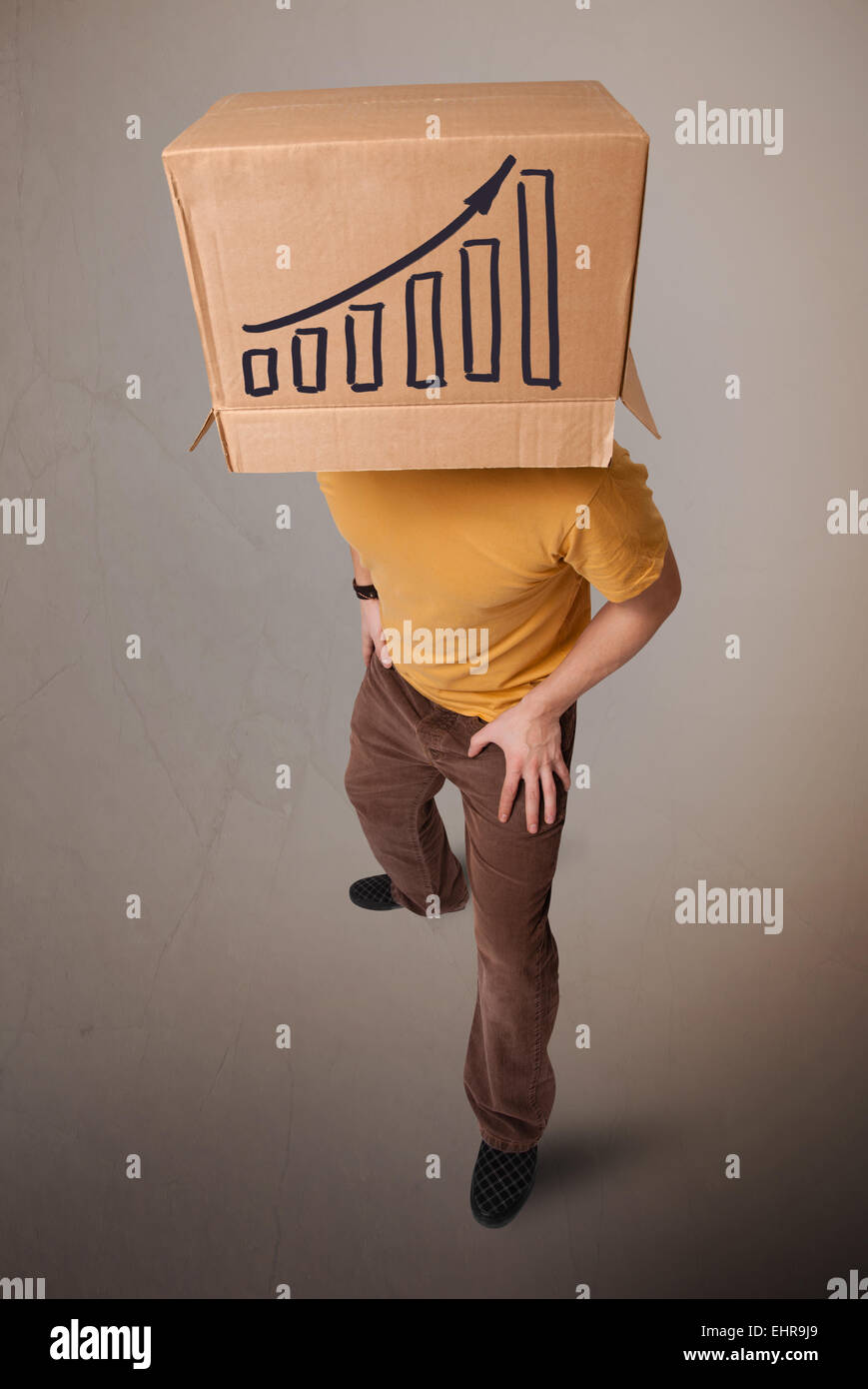 Young man gesturing with a cardboard box on his head with diagram Stock ...