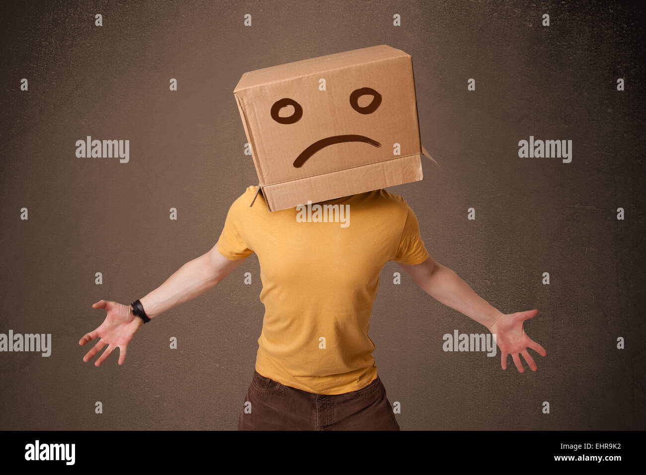 Young man with a brown cardboard box on his head with sad face Stock ...