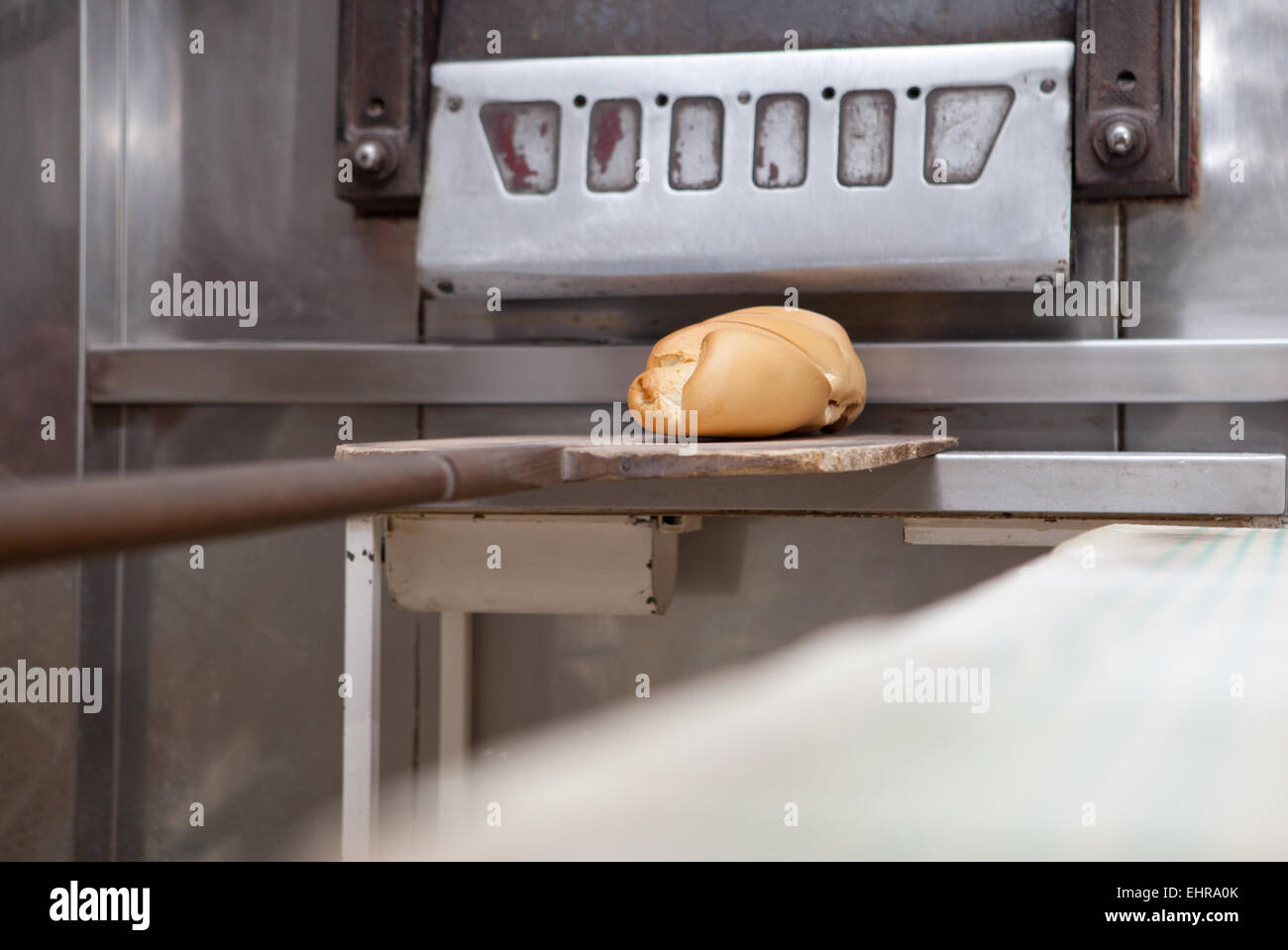baking peel with fresh baked bread. Manufacturing process of spanish ...
