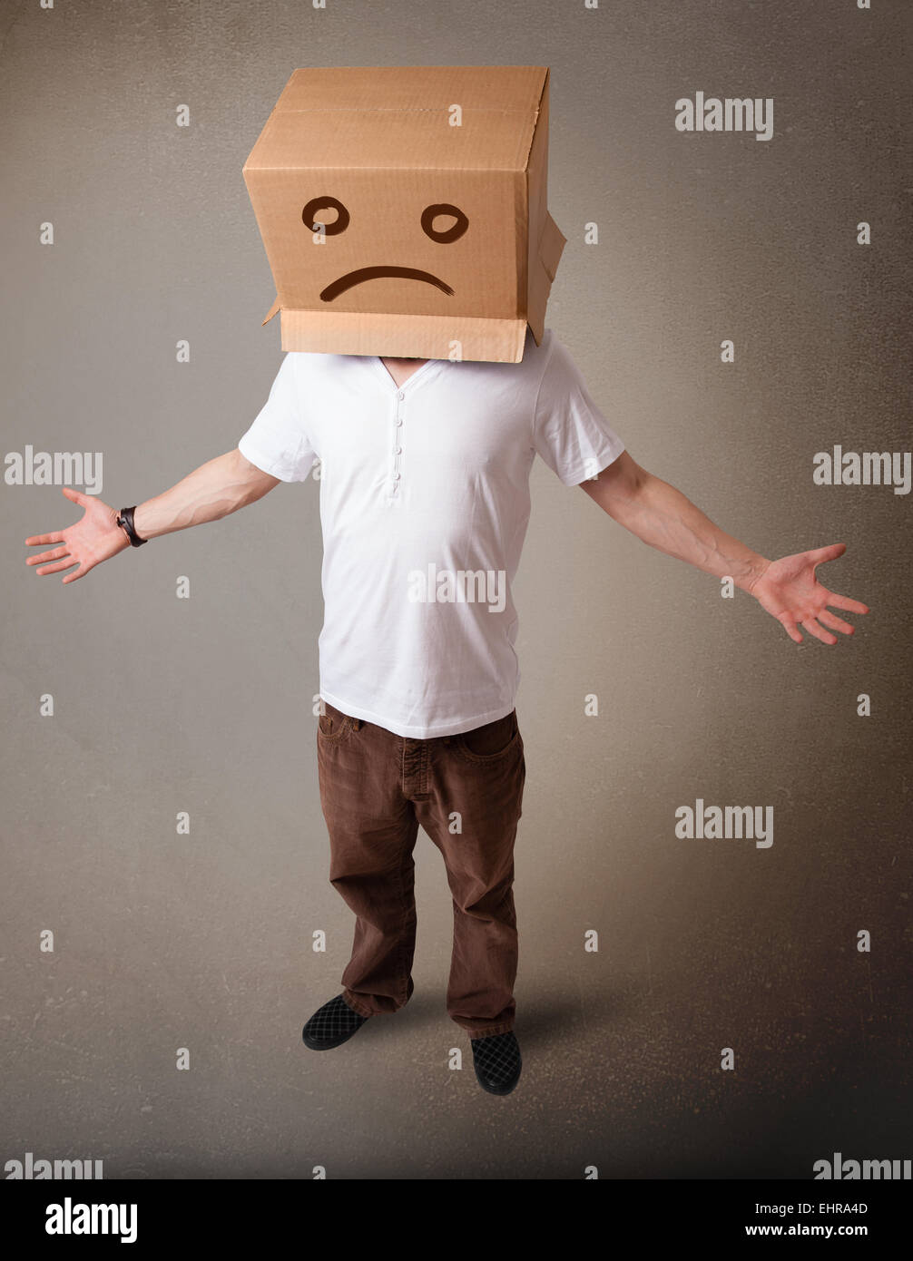 Young man with a brown cardboard box on his head with sad face Stock ...