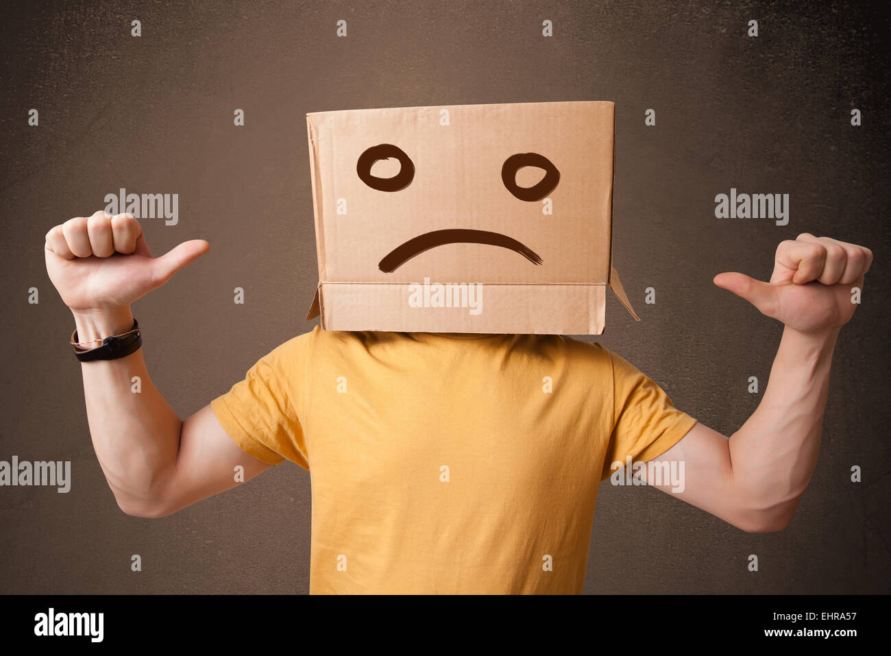 Young man with a brown cardboard box on his head with sad face Stock ...