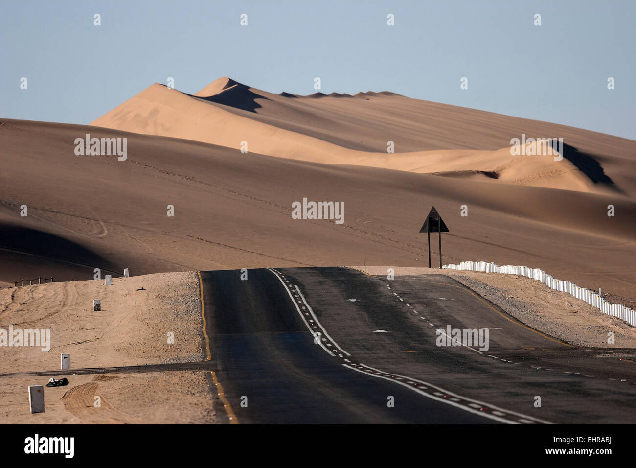 Road B2 between Swakopmund and Walvis Bay, sand dunes at the back ...