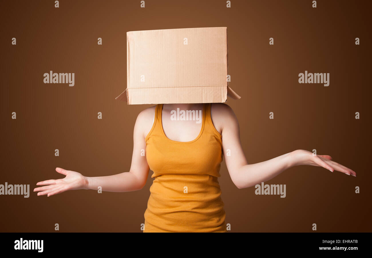 Young girl gesturing with a cardboard box on his head Stock Photo - Alamy