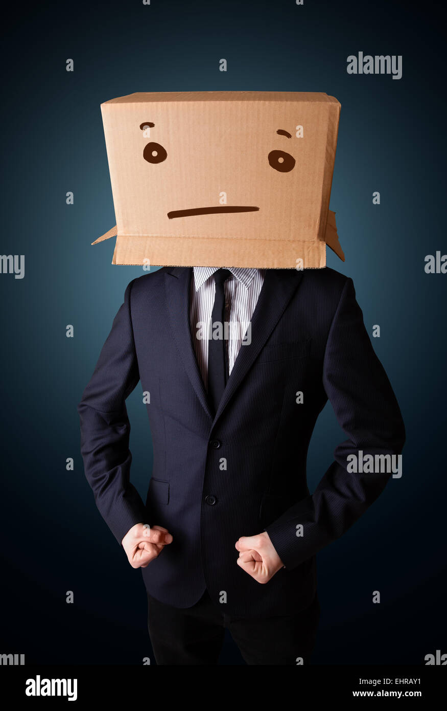 Businessman gesturing with a cardboard box on his head with straight ...