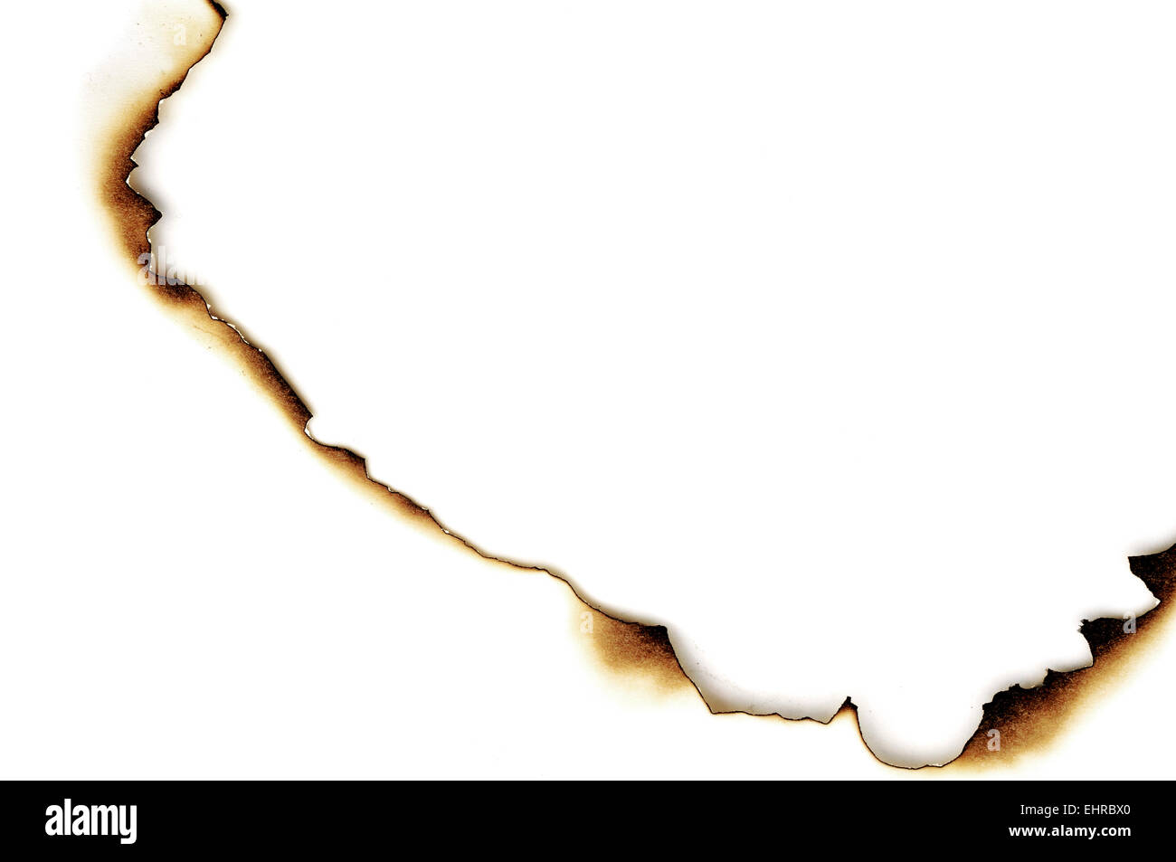 closeup of a burned white paper on a white background with a blank ...