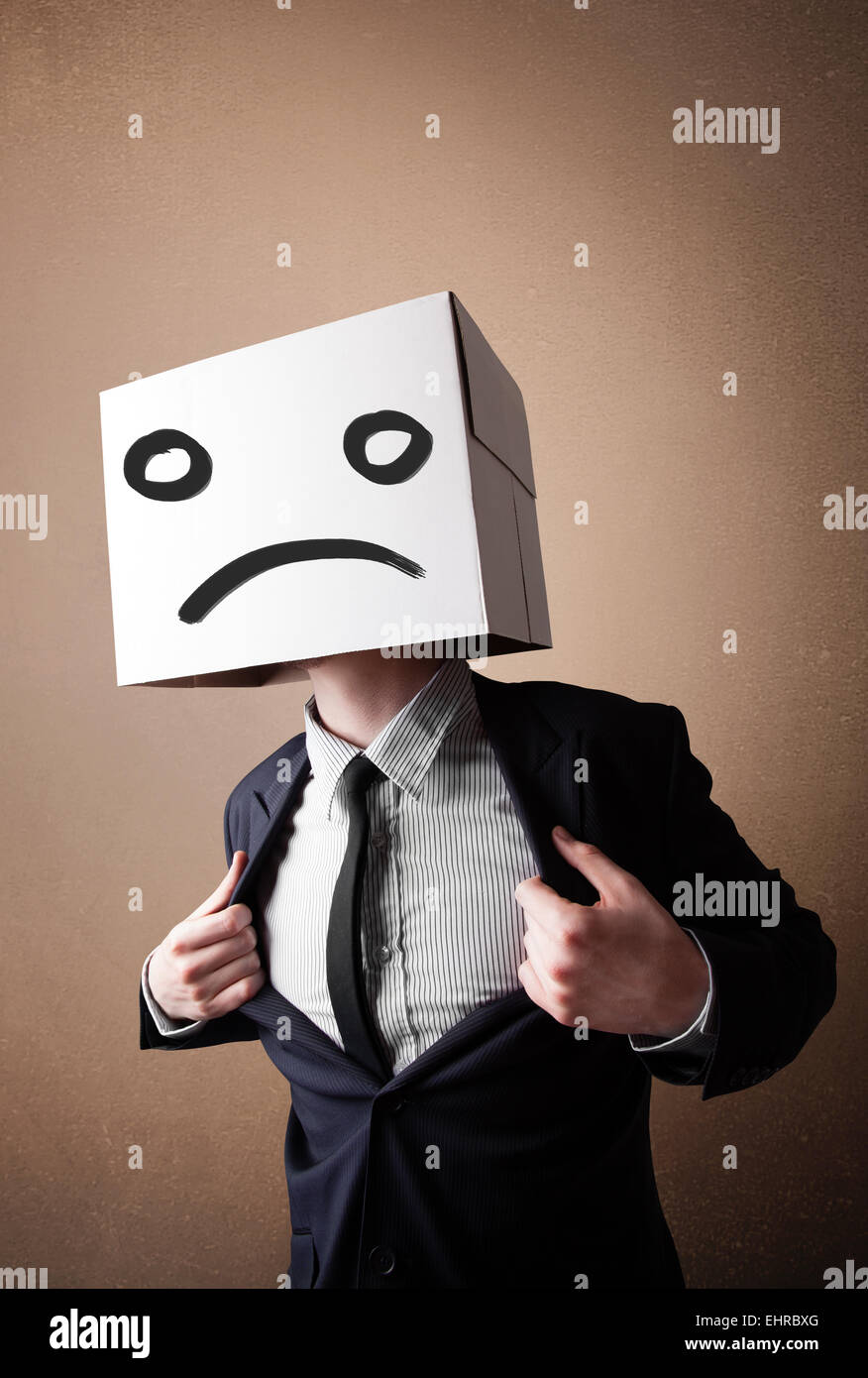 Businessman gesturing with cardboard box on his head with sad face ...