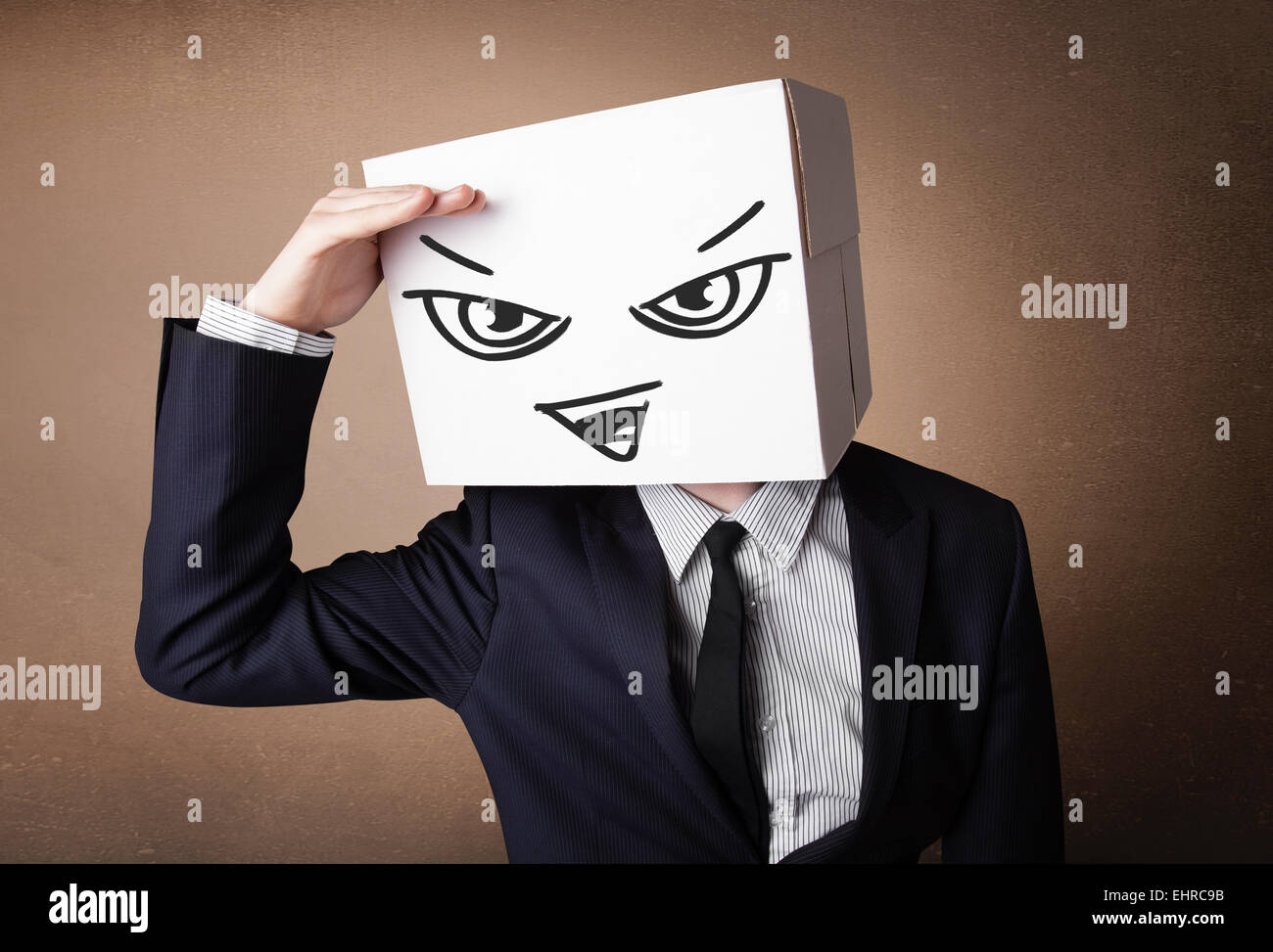 Businessman gesturing with a cardboard box on his head with evil face ...