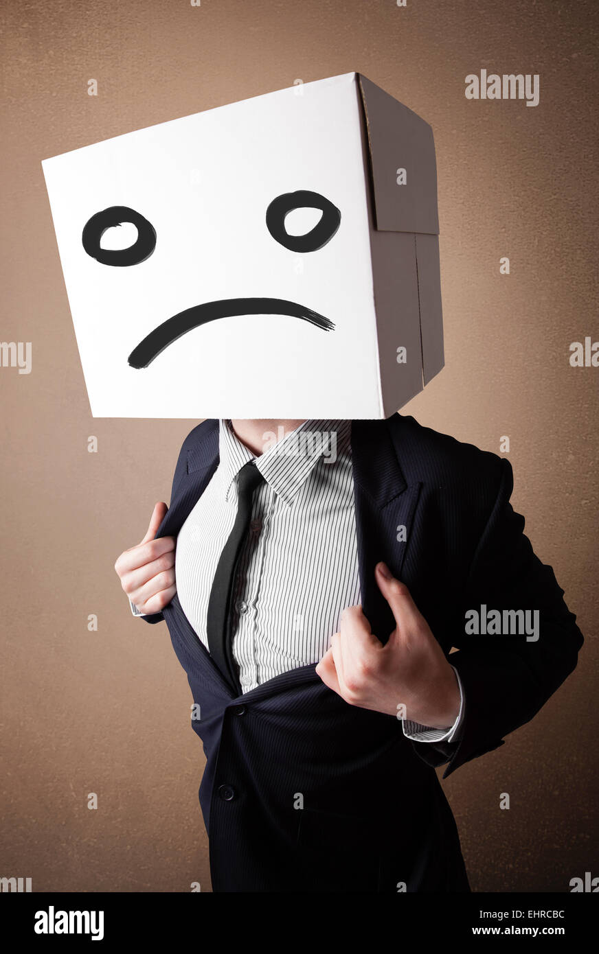 Businessman gesturing with cardboard box on his head with sad face ...