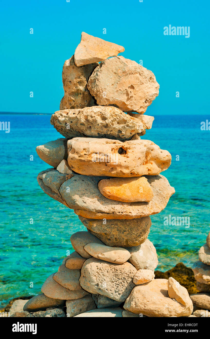 a stack of balanced stones on the beach in the summer Stock Photo - Alamy