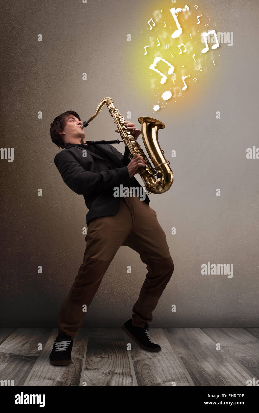 Handsome musician playing on saxophone with musical notes Stock Photo ...