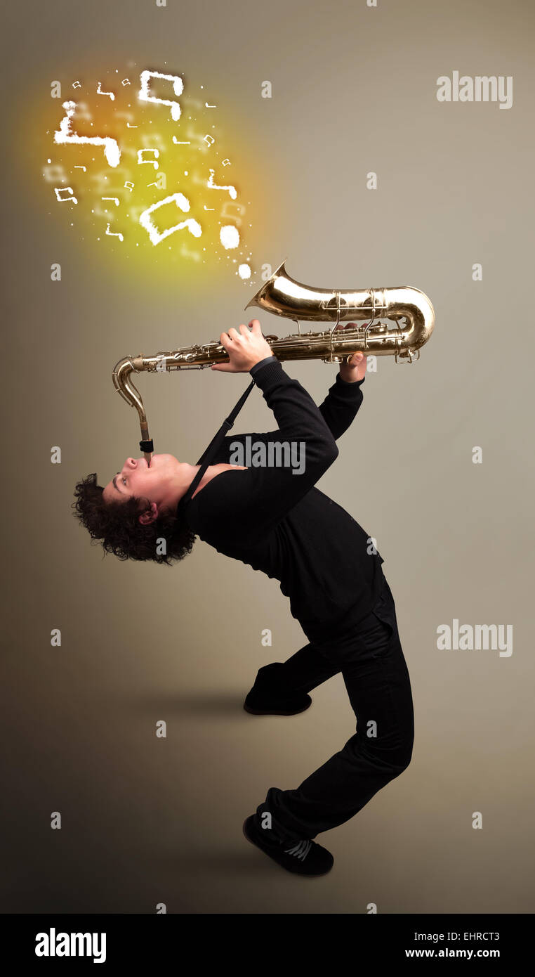 Handsome musician playing on saxophone with musical notes Stock Photo ...