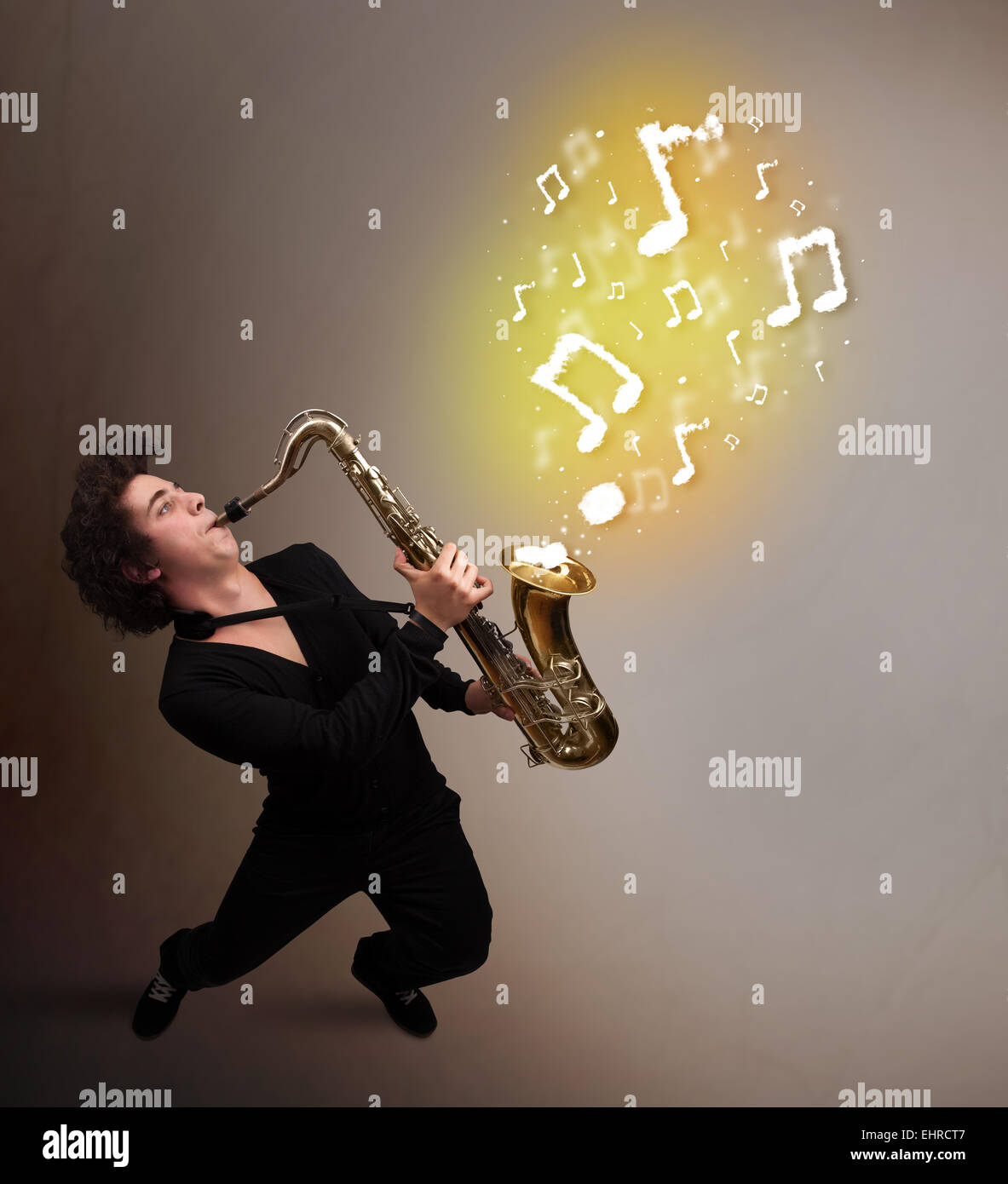 Handsome musician playing on saxophone with musical notes Stock Photo ...