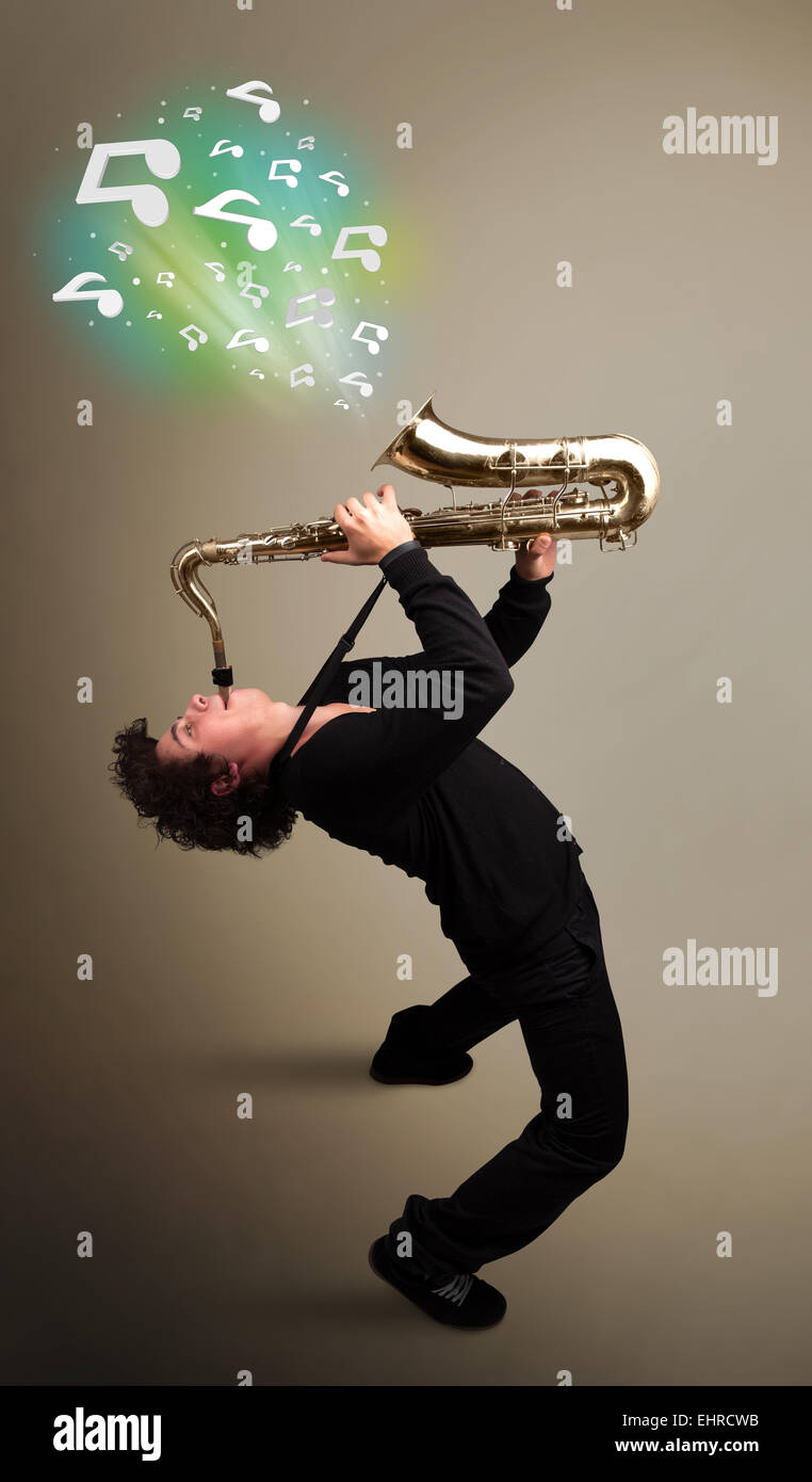 Young musician playing on saxophone while musical notes exploding Stock ...