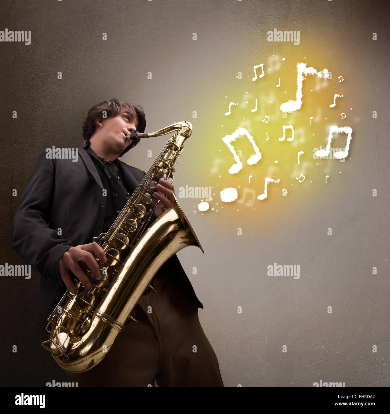Handsome musician playing on saxophone with musical notes Stock Photo ...