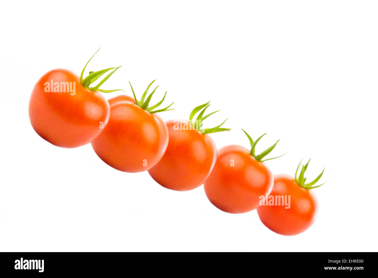 Five tomatoes in a row Stock Photo - Alamy