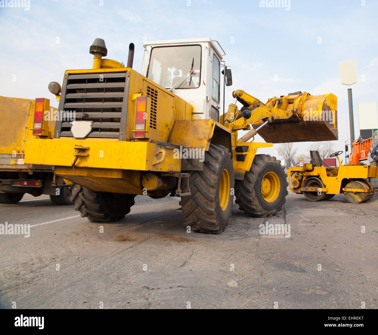 Front loader on the road repair works Stock Photo - Alamy