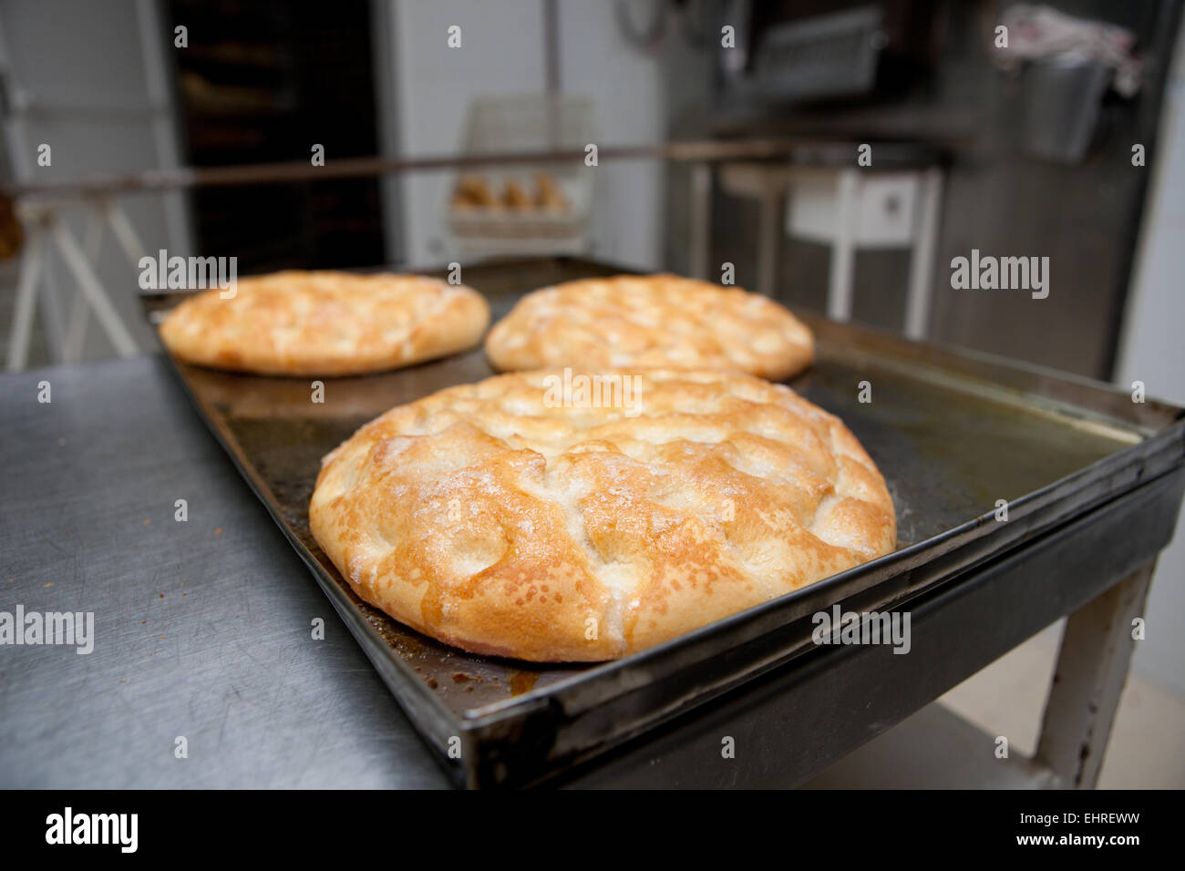 Elaboration process of traditional spanish olive oil pancakes. Baker ...