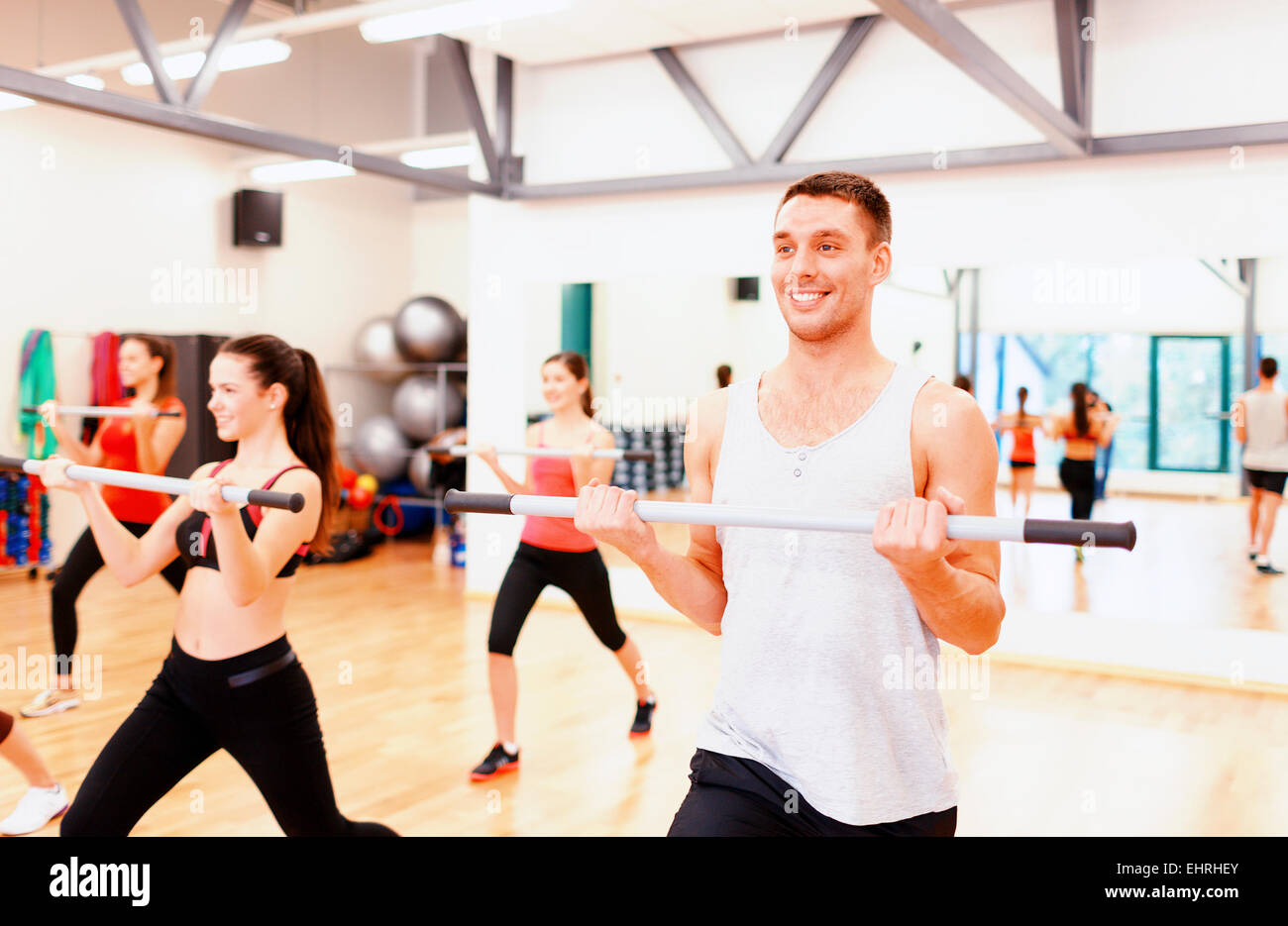 group of smiling people working out with barbells Stock Photo - Alamy