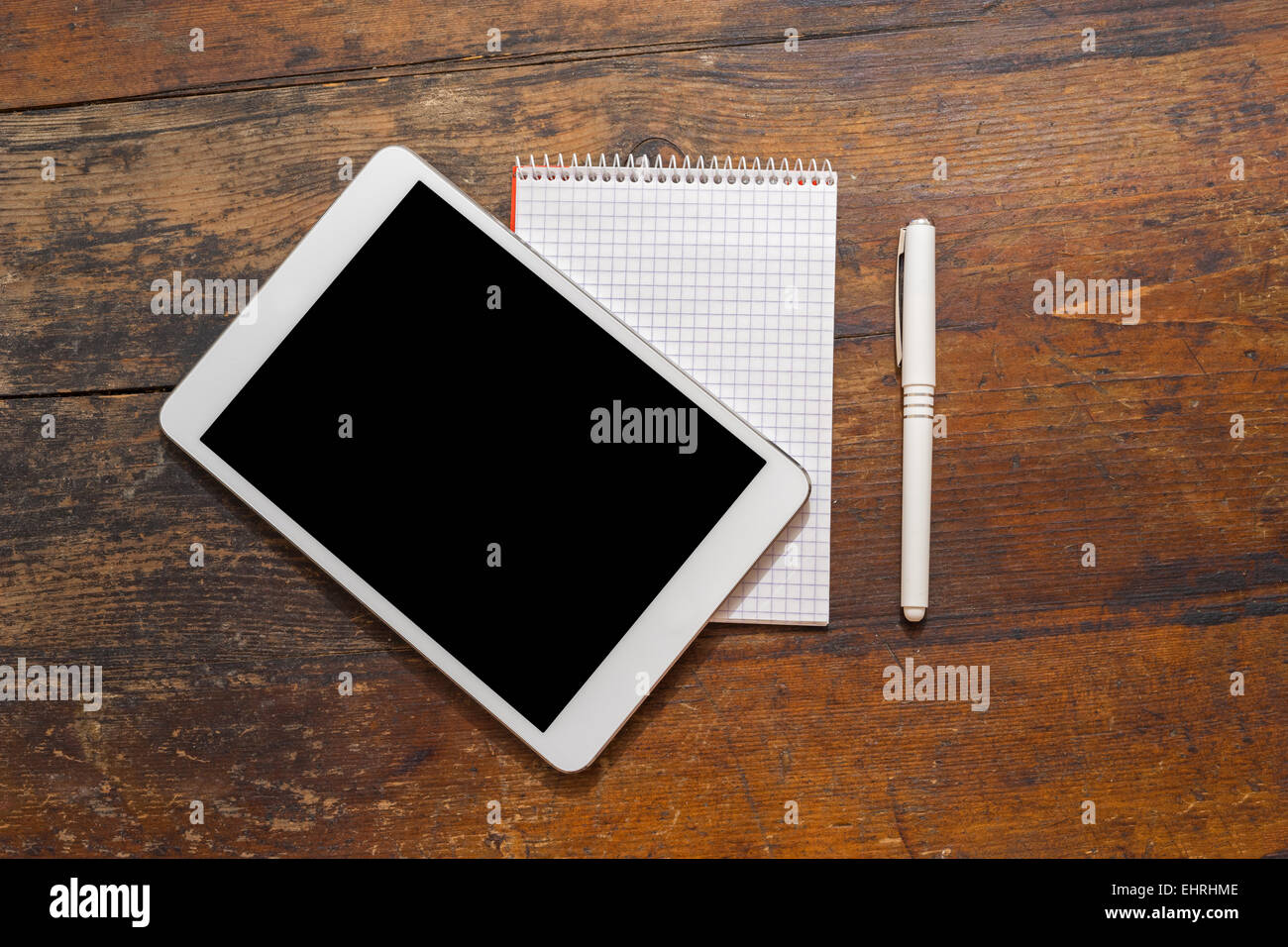 Digital tablet on wooden tablets with notepad and pen Stock Photo - Alamy