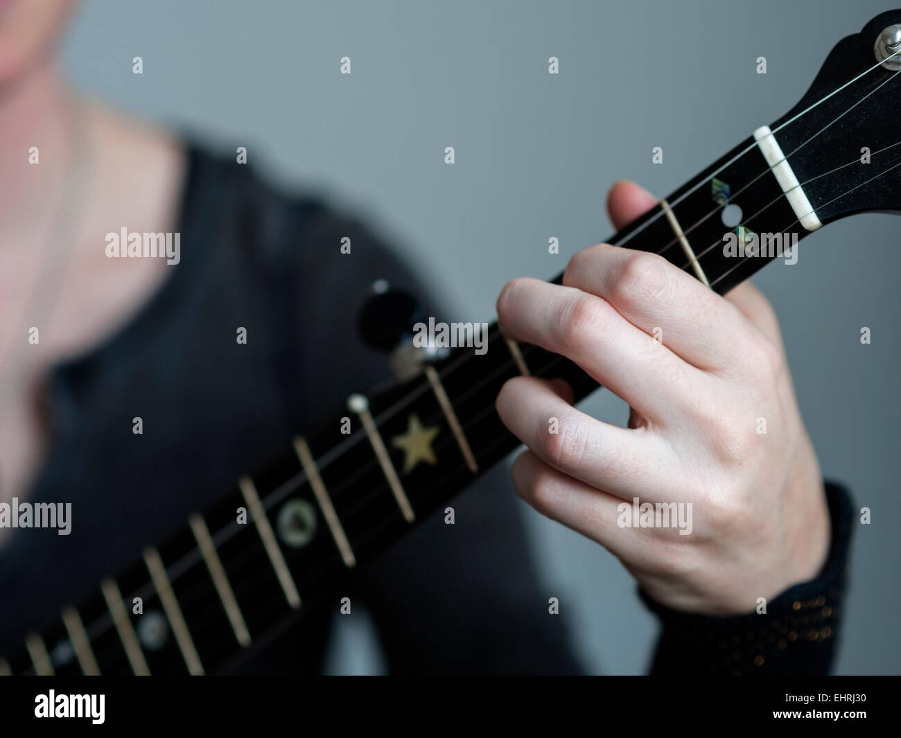 Closeup of a womans hands playing a banjo Stock Photo - Alamy