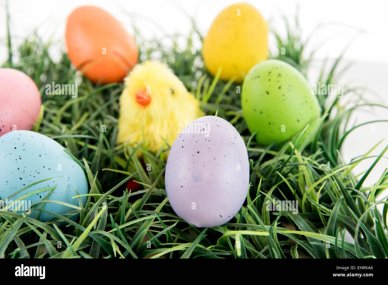 colored Easter eggs and spring chick on grass Stock Photo - Alamy