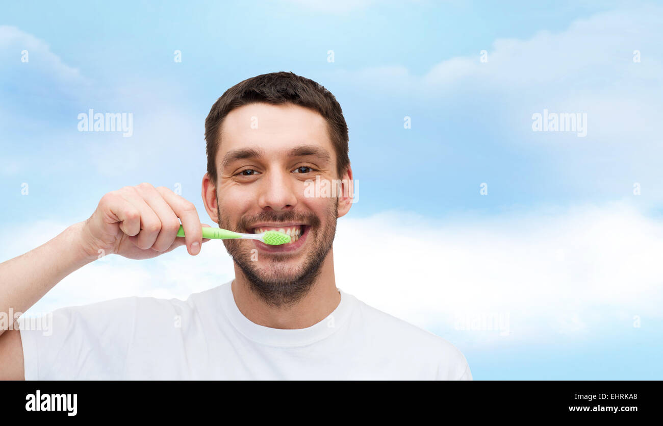 smiling young man with toothbrush Stock Photo - Alamy