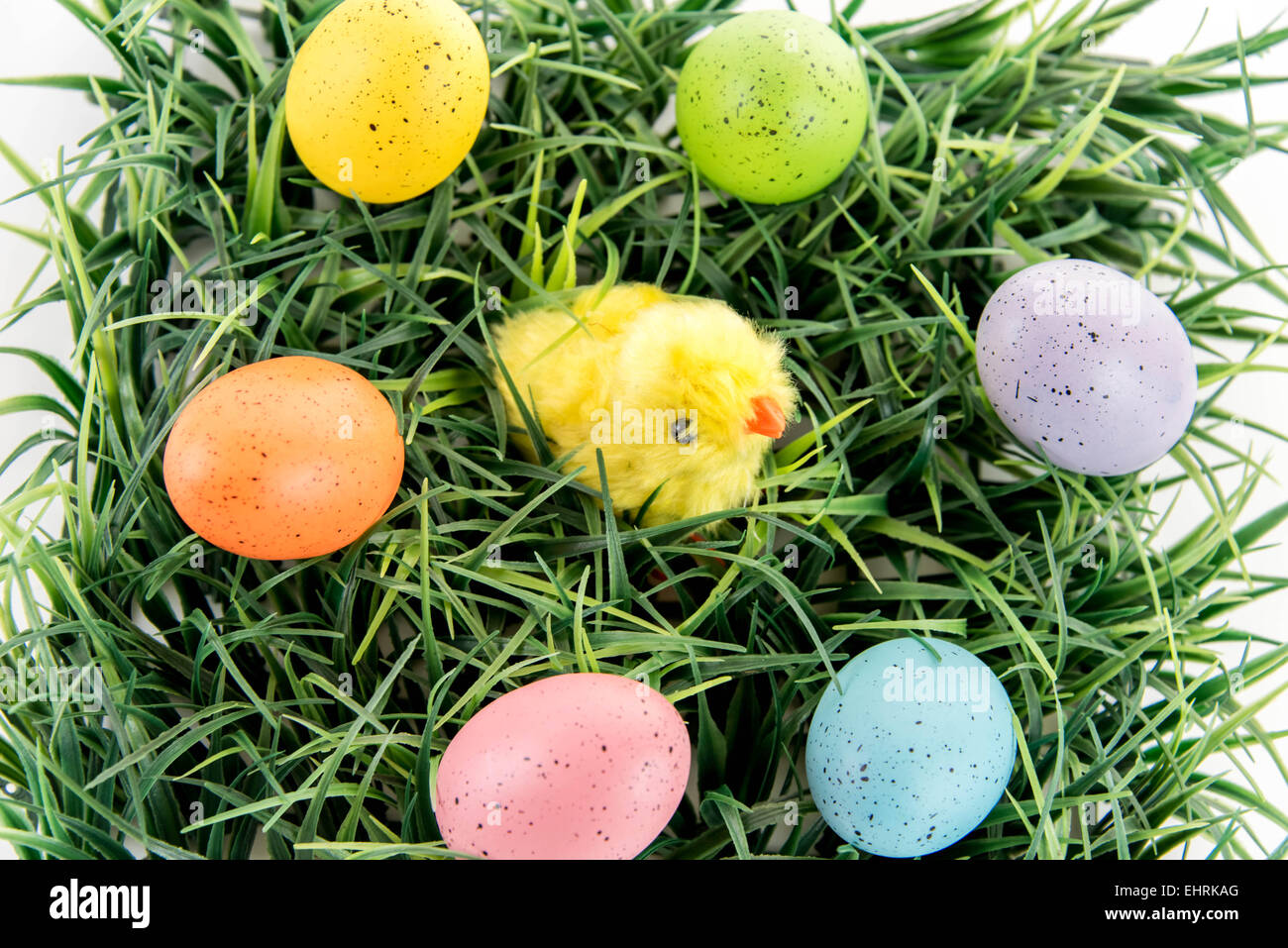 colored Easter eggs and spring chick on grass Stock Photo - Alamy