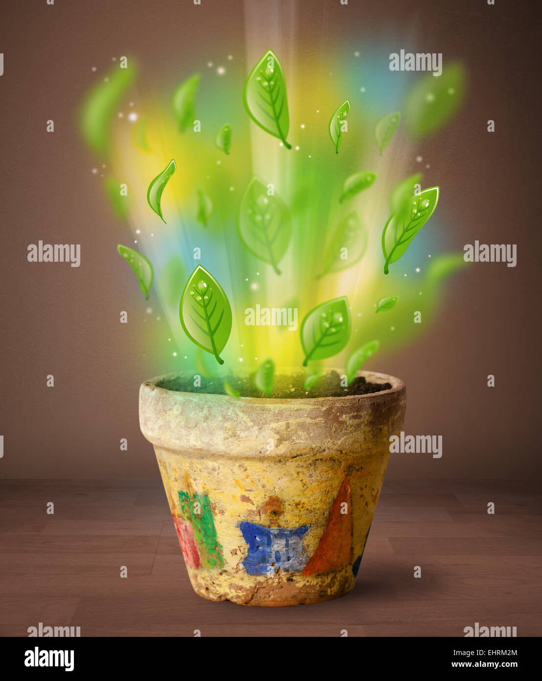 Glowing leaves coming out of flowerpot Stock Photo - Alamy