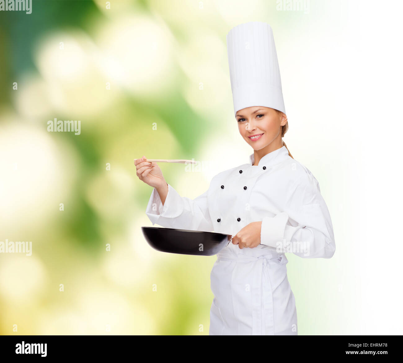 smiling female chef with pan and spoon Stock Photo - Alamy
