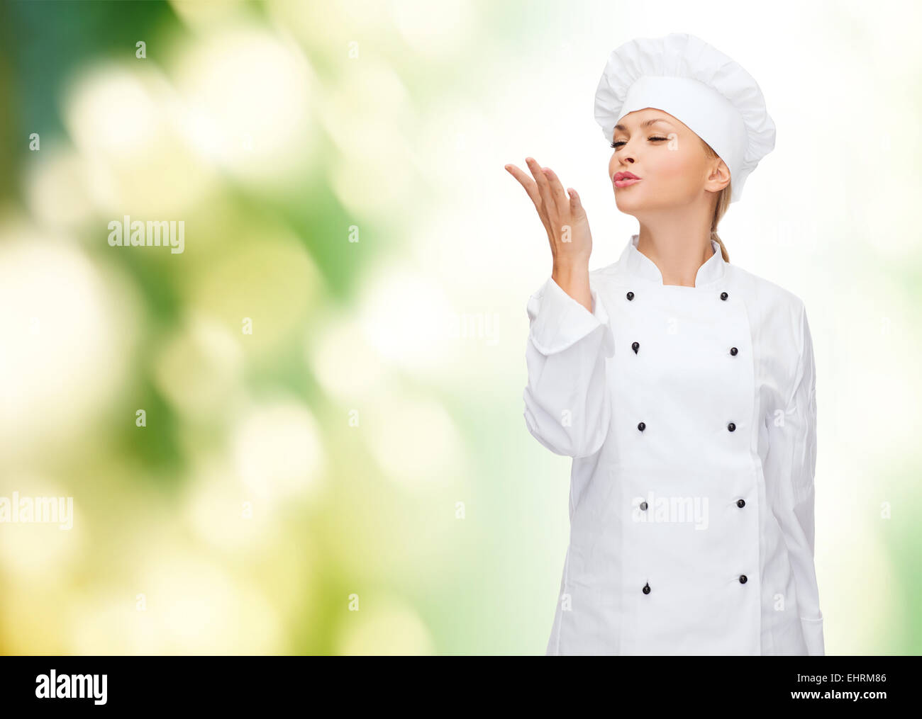 smiling female chef showing delicious sign Stock Photo - Alamy