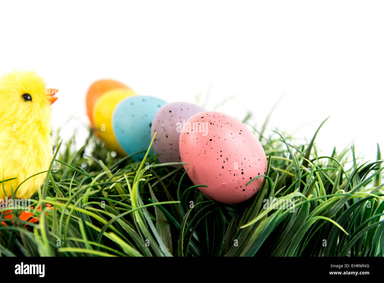 colored Easter eggs and spring chick on grass Stock Photo - Alamy