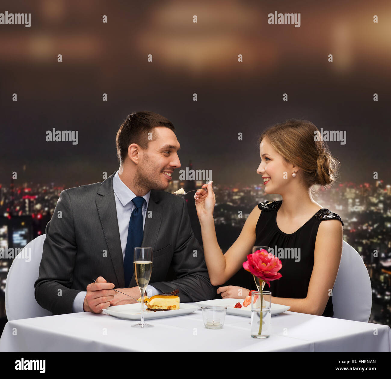 smiling couple eating dessert at restaurant Stock Photo - Alamy