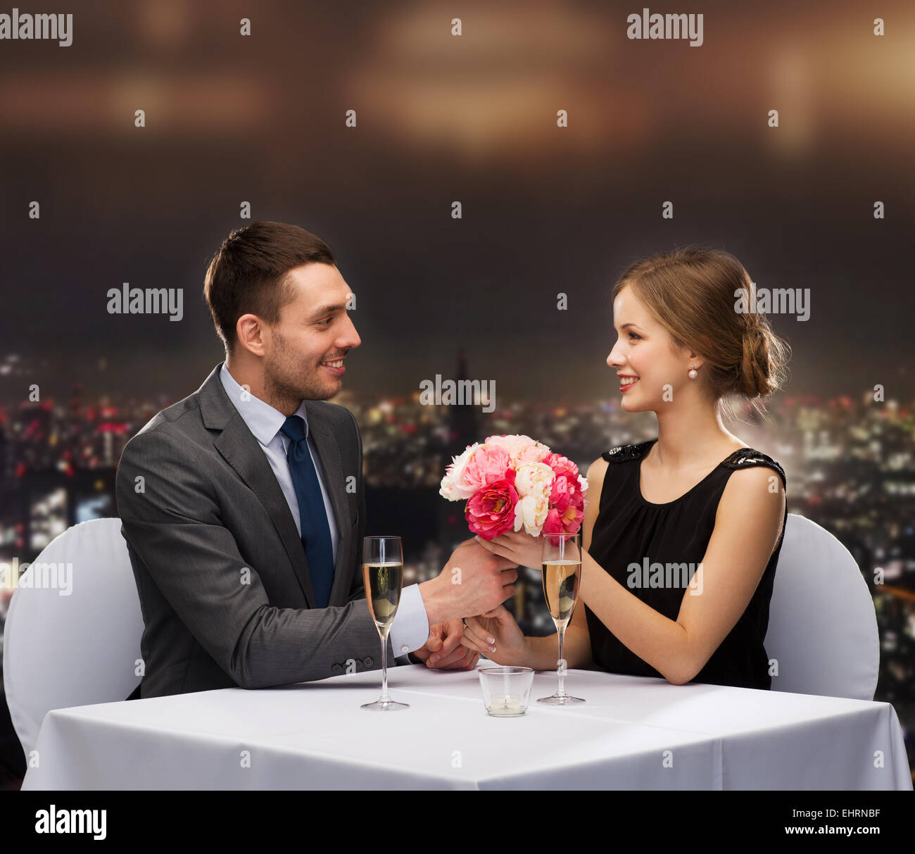 smiling man giving flower bouquet to woman Stock Photo - Alamy