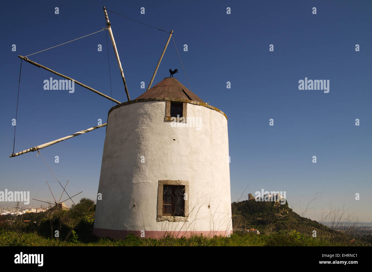 Windmill against Palmela castle Stock Photo - Alamy