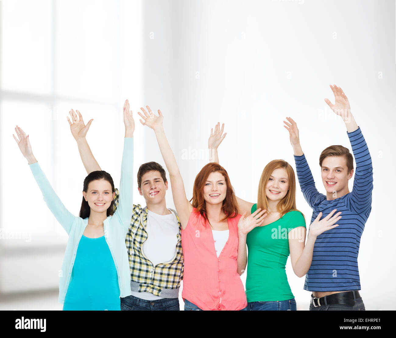 group of smiling students waving hands Stock Photo - Alamy