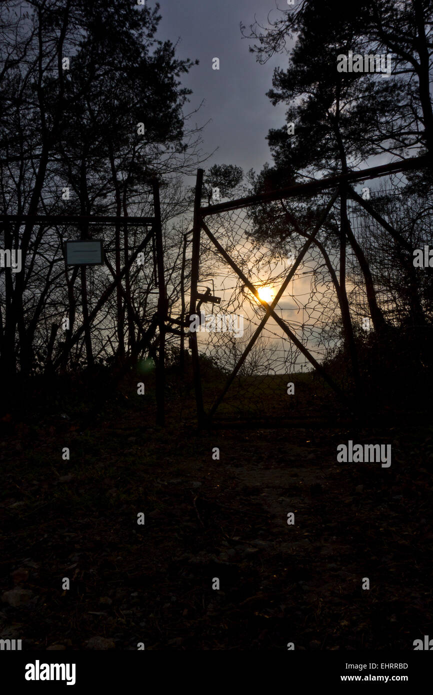 old security gate wasteland sunset Stock Photo - Alamy
